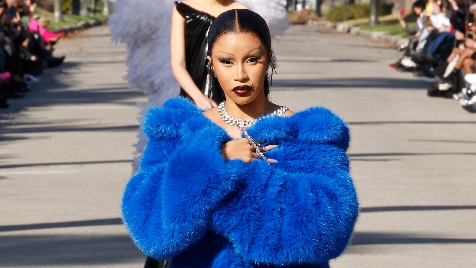 The "Drip" rapper made her modeling debut in a faux fur blue coat ...