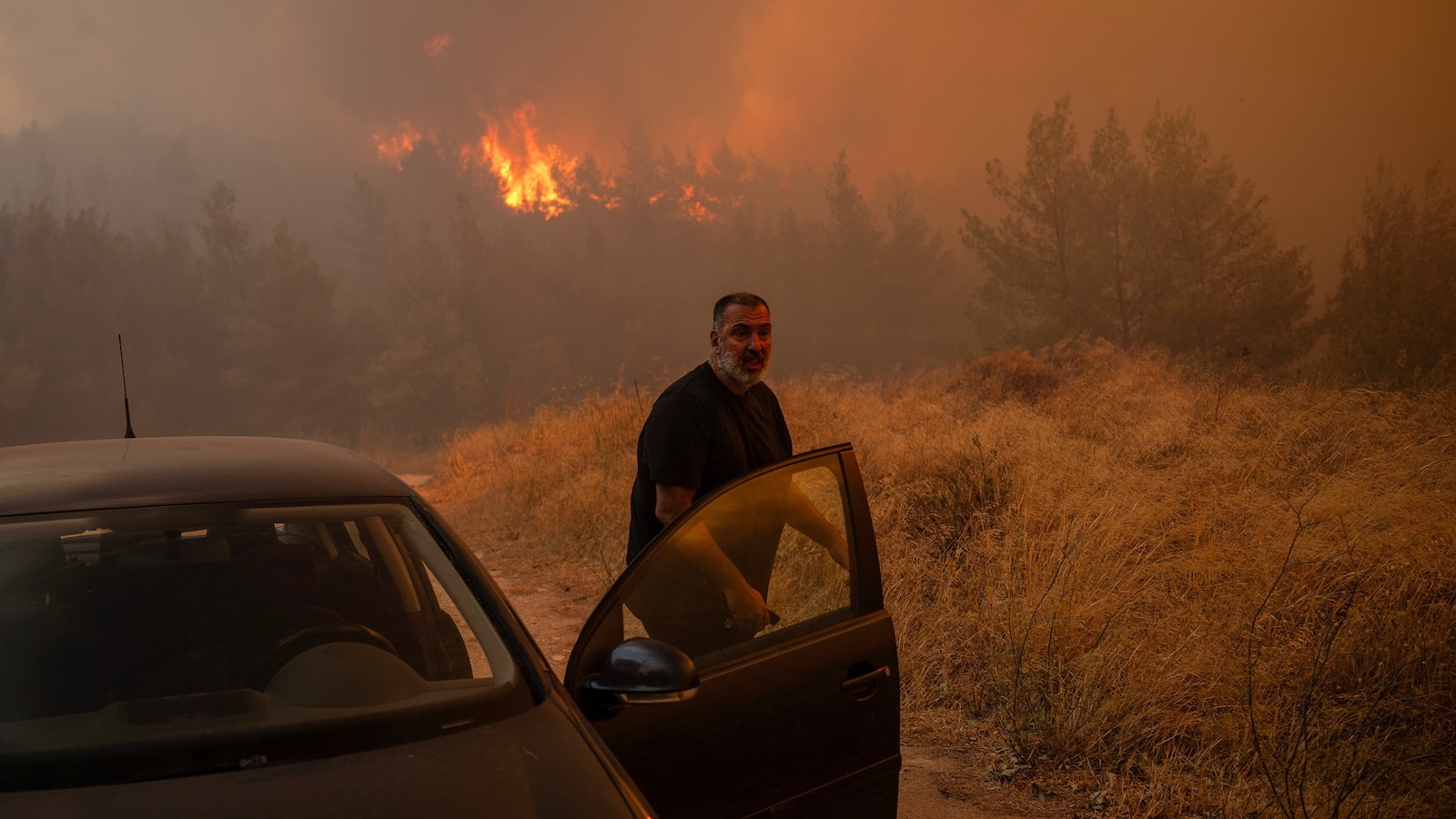 Wildfire spreads near Athens amid scorching heat, prompting evacuations ...